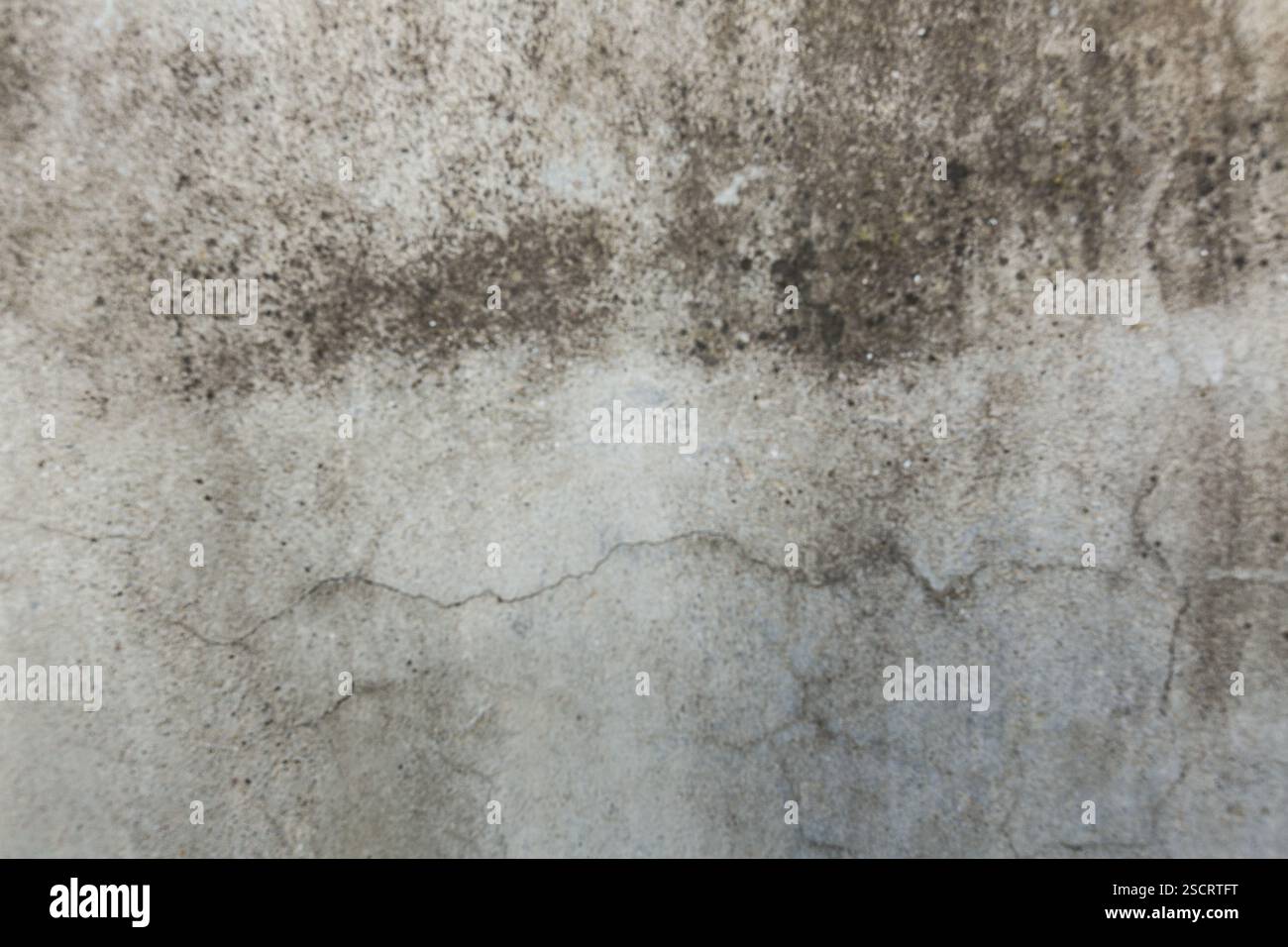 Surface with visible stains and cracks showing wear over time in an ...