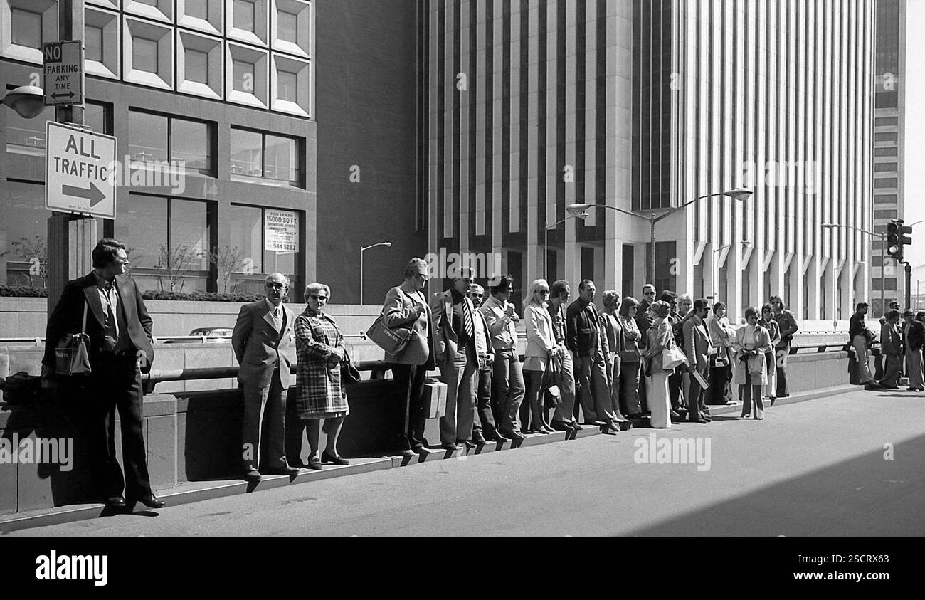 A group of people in a queue on the side of a road in New York City ...