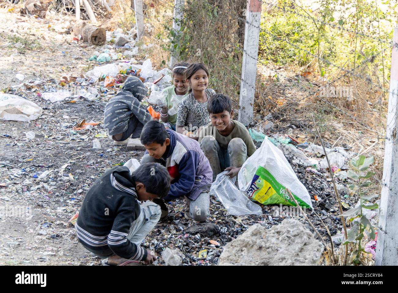 poverty stricken children collecting trash for recycling and selling in ...