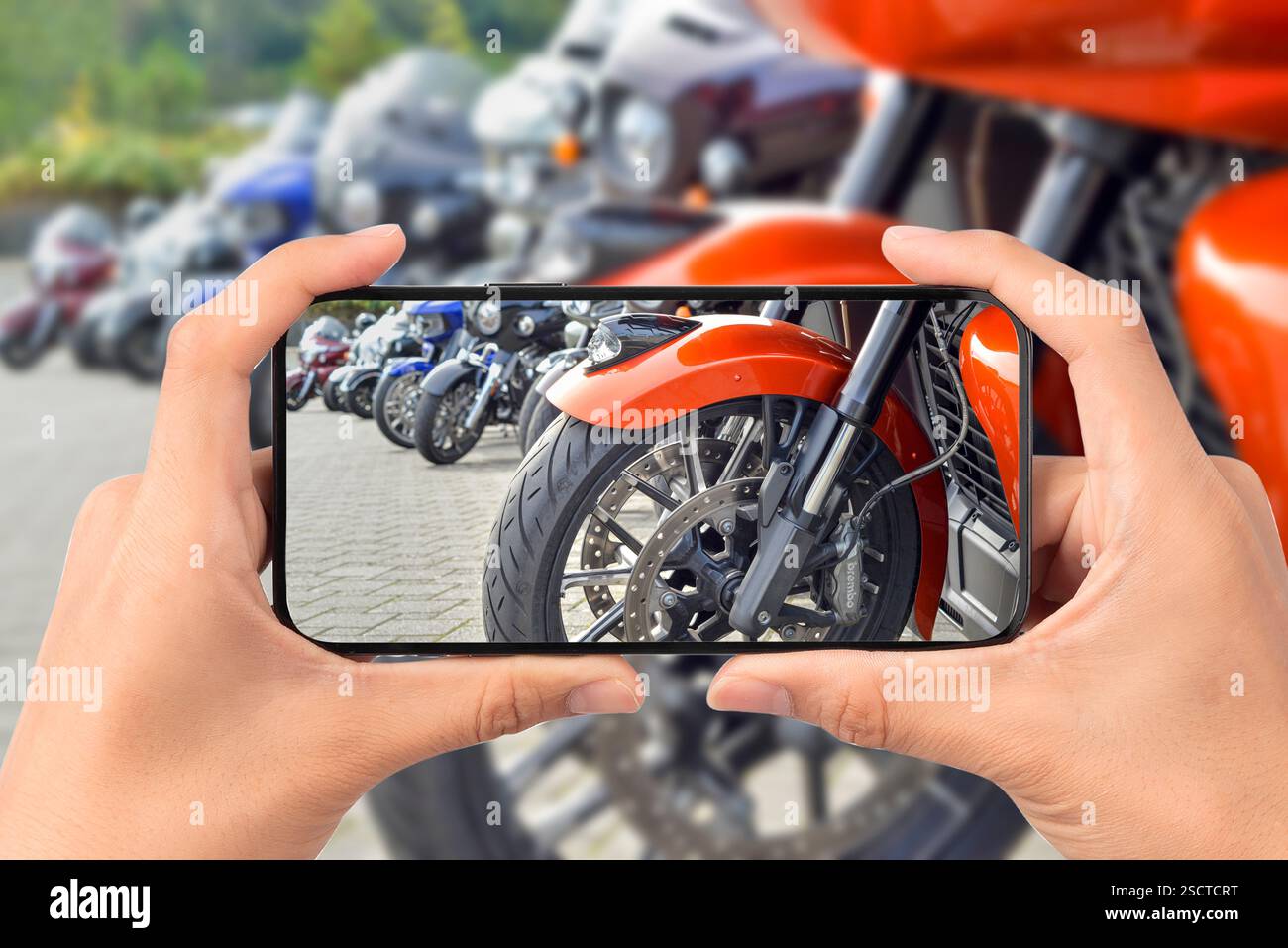 Cell phone taking a picture of a Indian motorcycle at a car show at the ...