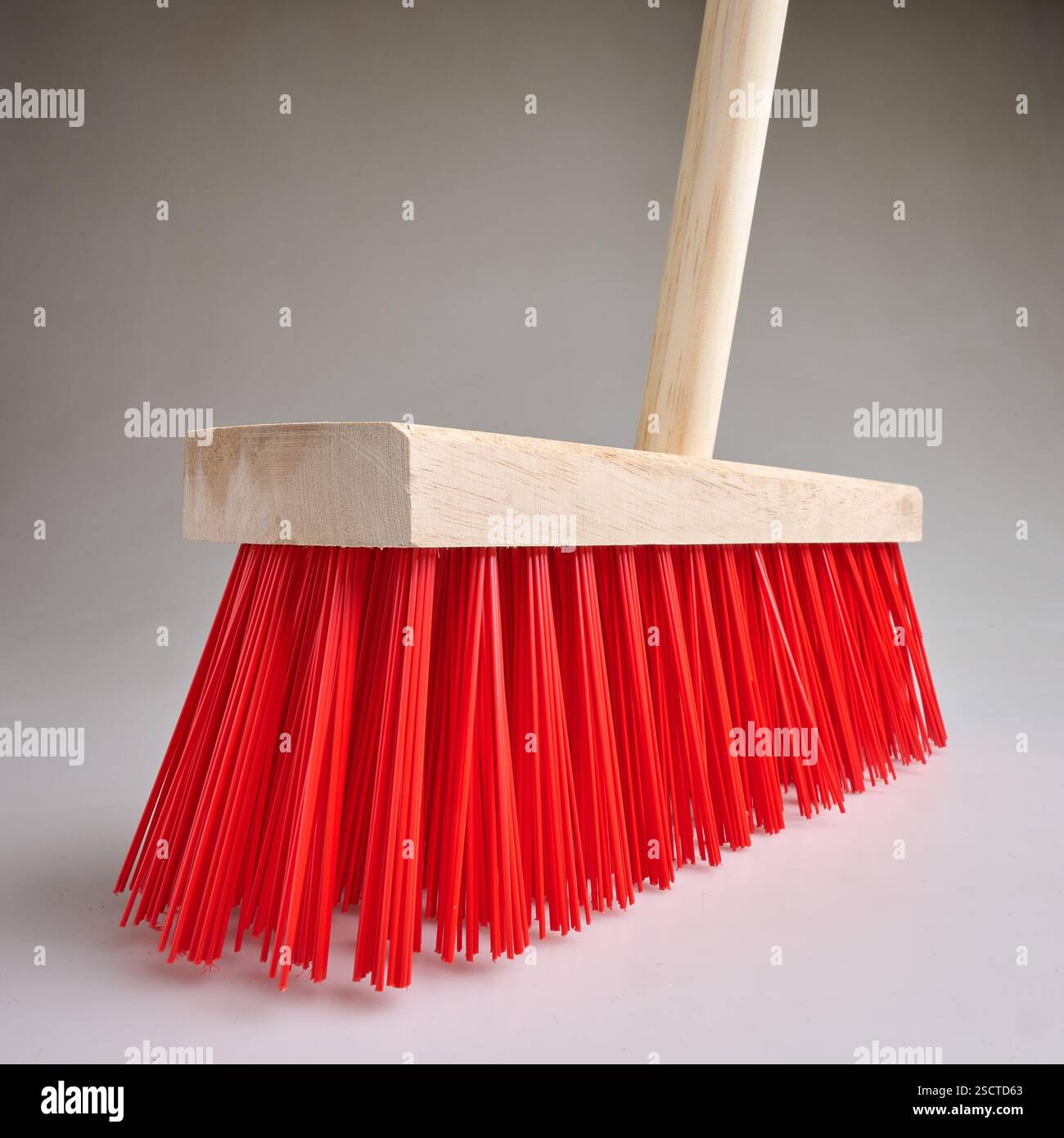 New and clean Red street broom in studio light on white background ...