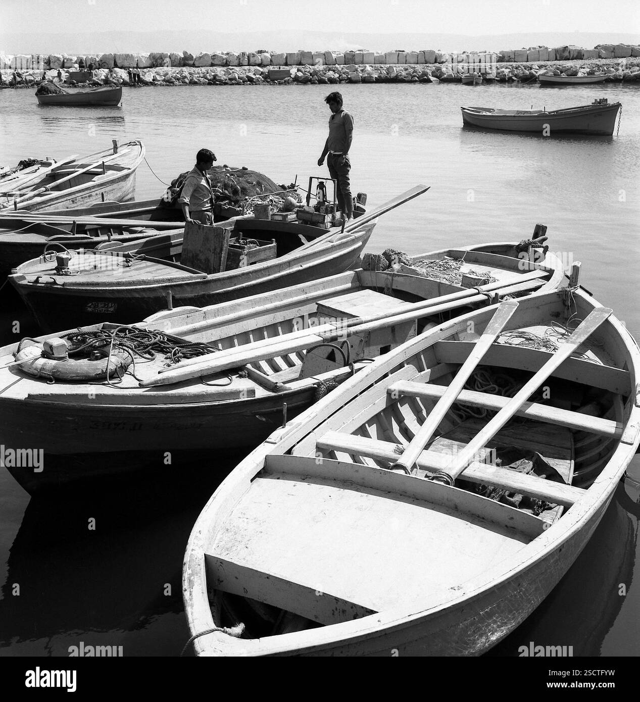 Two fishermen prepare for fishing at the fishing port of Acre in Israel ...