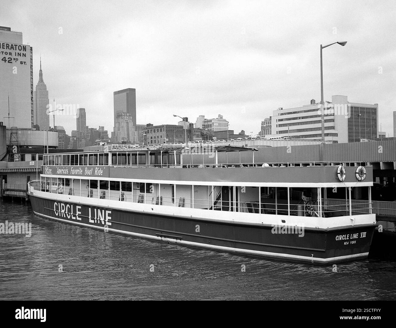 A Circle Line ferry at a landing stage on the Hudson River in New York ...