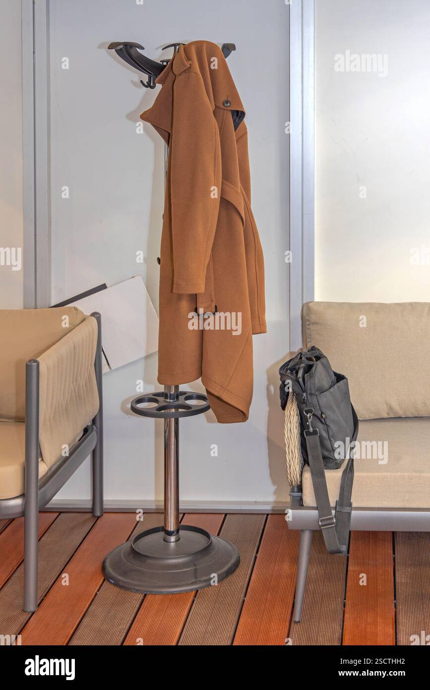 Brown Wool Winter Coat Hanging at Freestanding Pole Stand Rack Decking ...