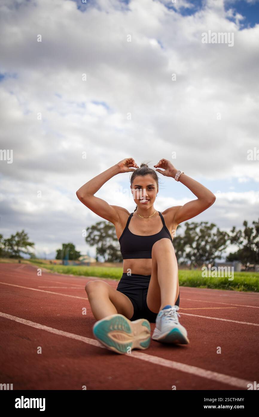 Female athlete in black sportswear training on a professional running ...
