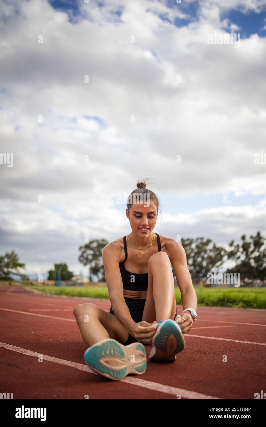 Female athlete in black sportswear training on a professional running ...