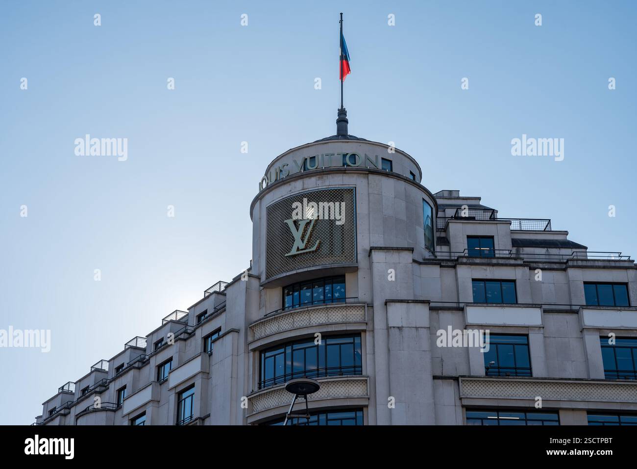Elegance shines from a luxury brand building in Paris under a clear sky ...