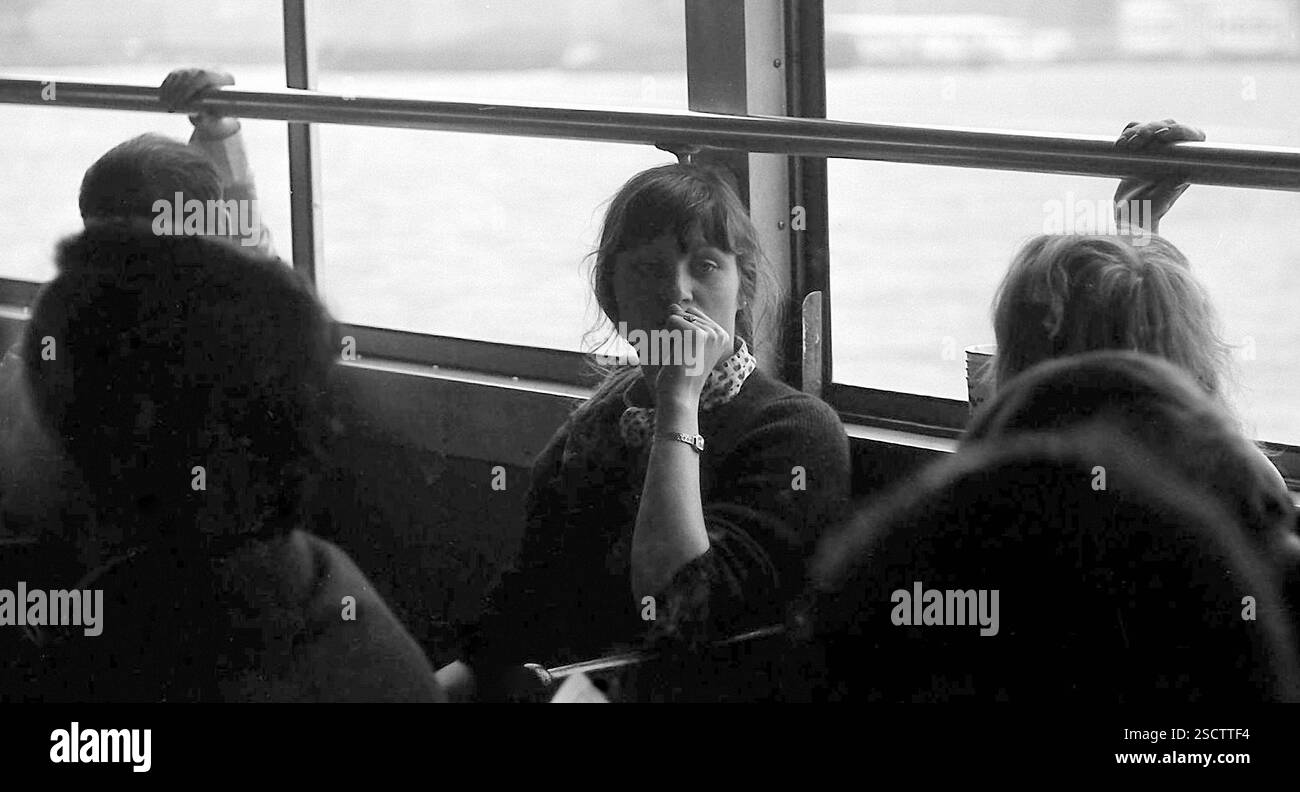 A young woman gazes thoughtfully into the camera on a Circle Line ride ...