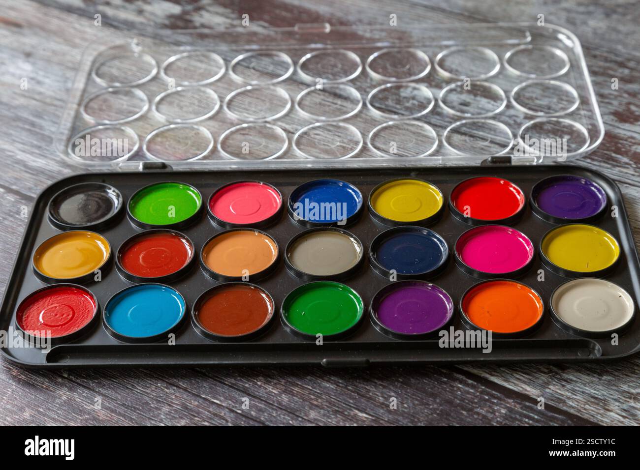 A set of brightly coloured paints for watercolour painting. Children's ...