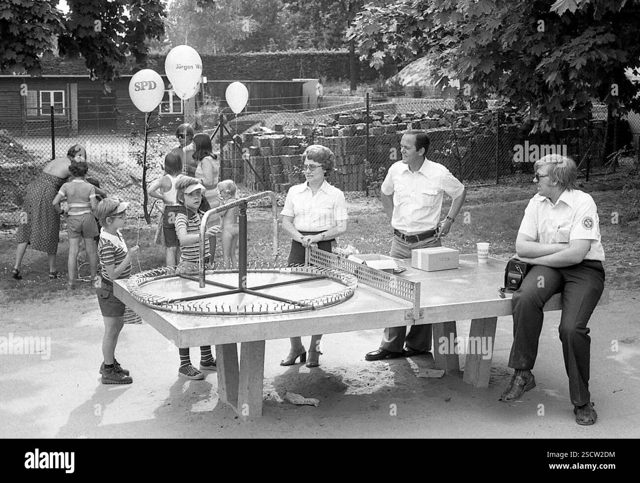 Children spin a wheel of fortune on a table tennis table. Berlin 1978 ...
