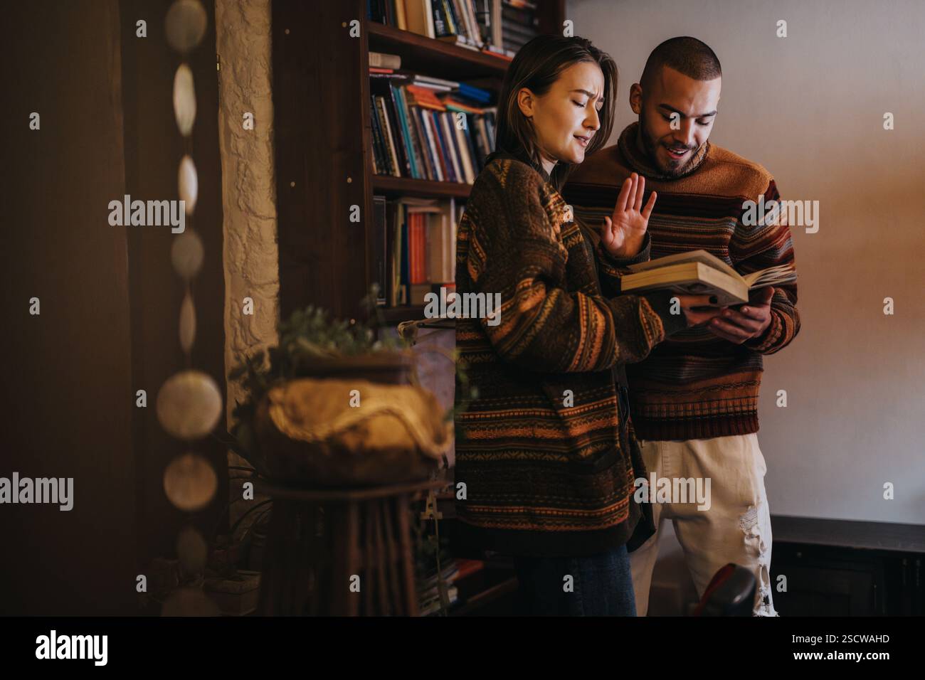 Two friends sharing a moment while discussing a book in a cozy library ...