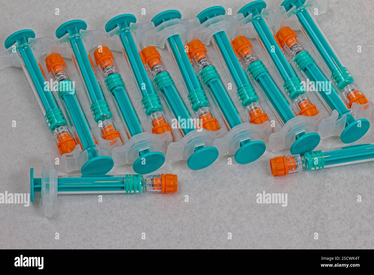 Pile of empty sterile medical plastic syringes on a table interior ...