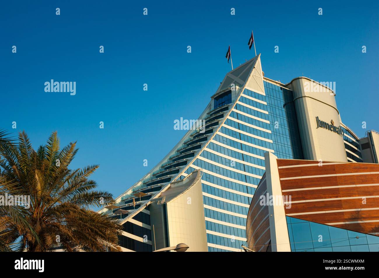DUBAI, UAE - November 15: Palm trees waving in the wind and giant chess ...