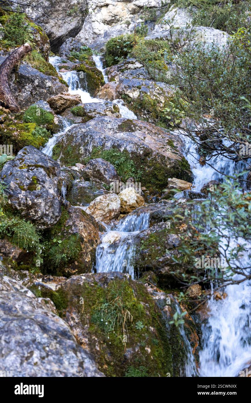 Water streams from Pisciadu waterfall flow over moss covered rocks ...