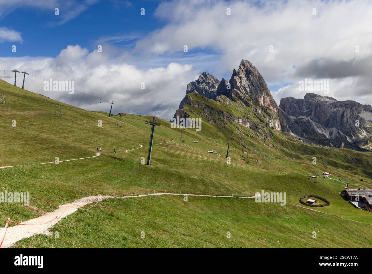 The rugged cliffs of Seceda rise above vast green meadows with ...