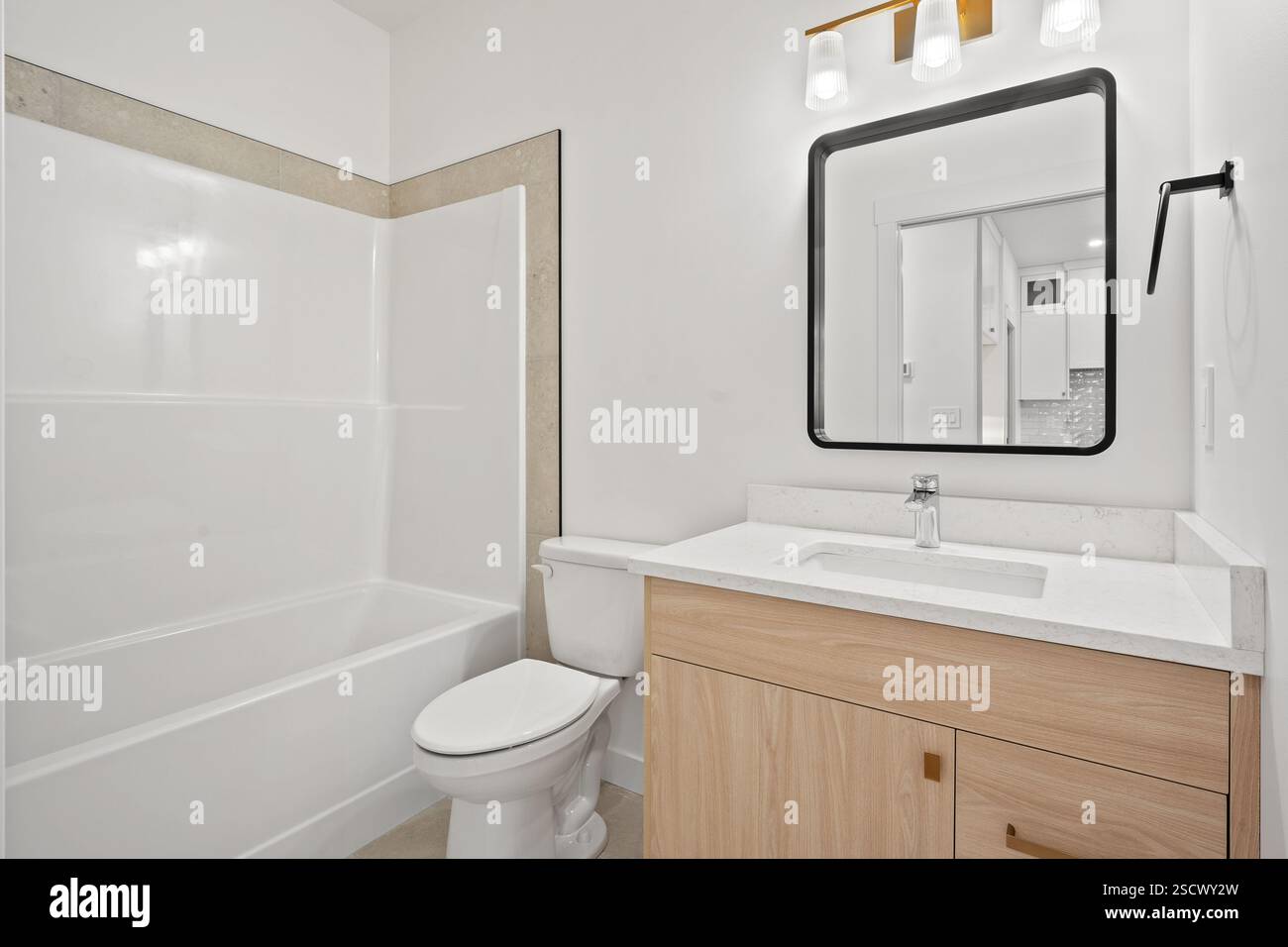 A bathroom with a white toilet and a white sink. The bathroom is clean ...