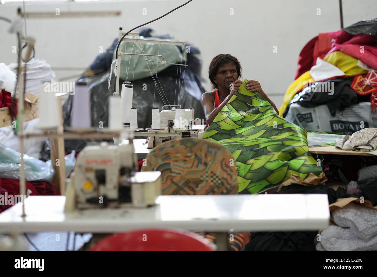 A member of the "Unidos de Padre Miguel" samba school works on a ...