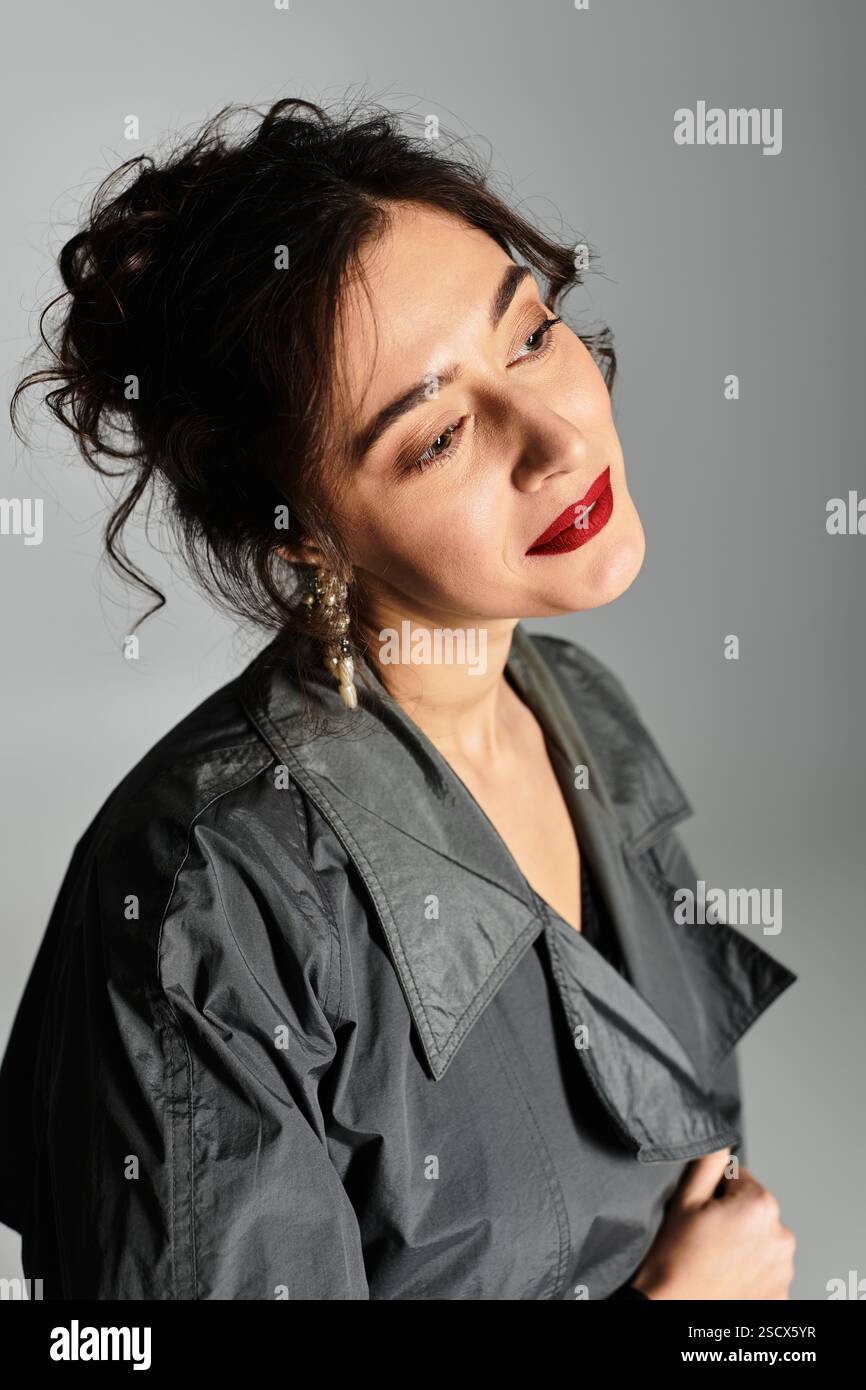 Elegant brunette woman in refined attire poses gracefully against a ...