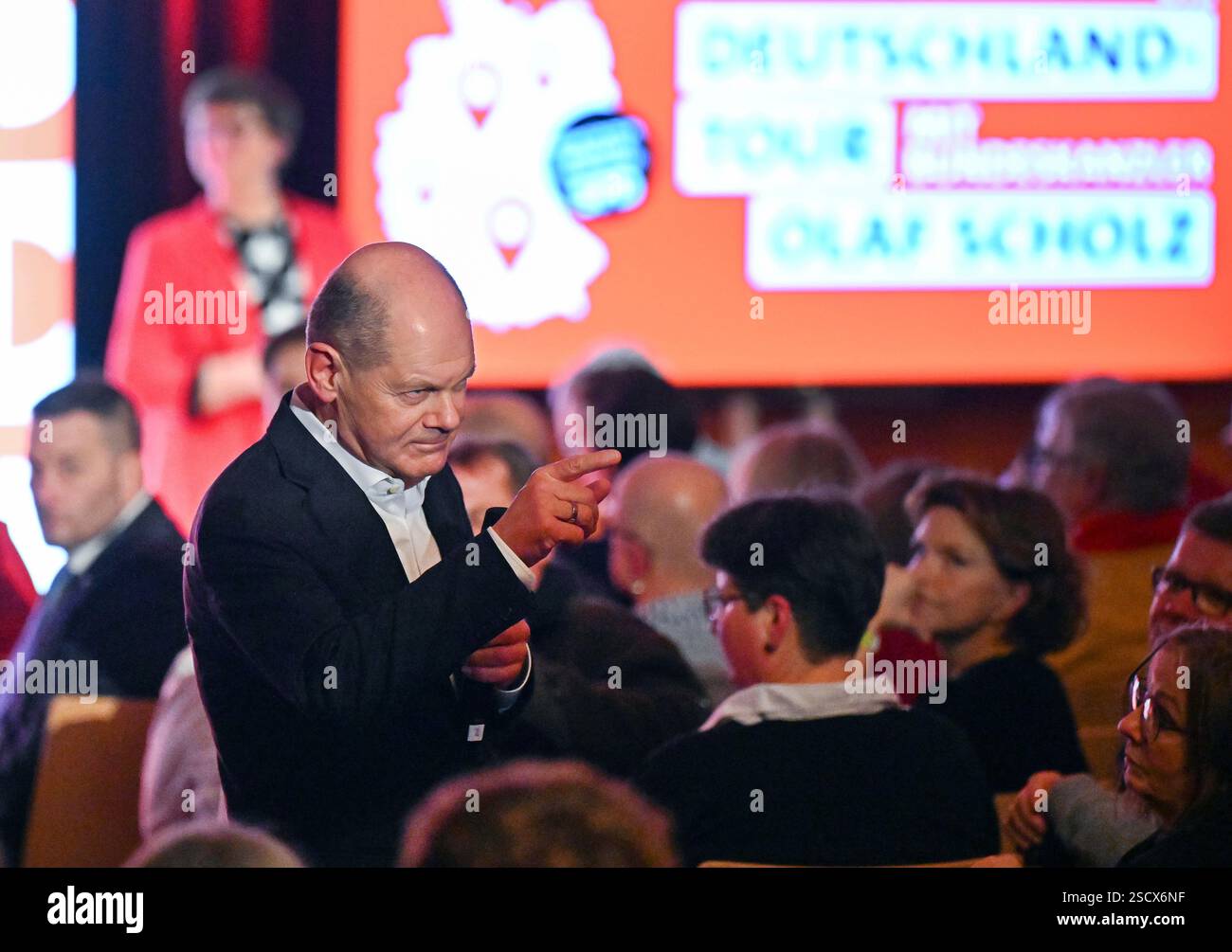 German Chancellor Olaf Scholz speaks at a townhall event as part of his ...