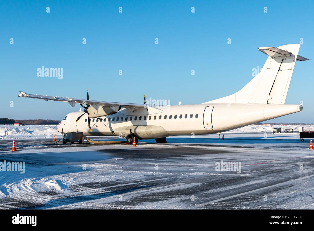 White passenger turboprop aircraft on the winter airport Stock Photo ...