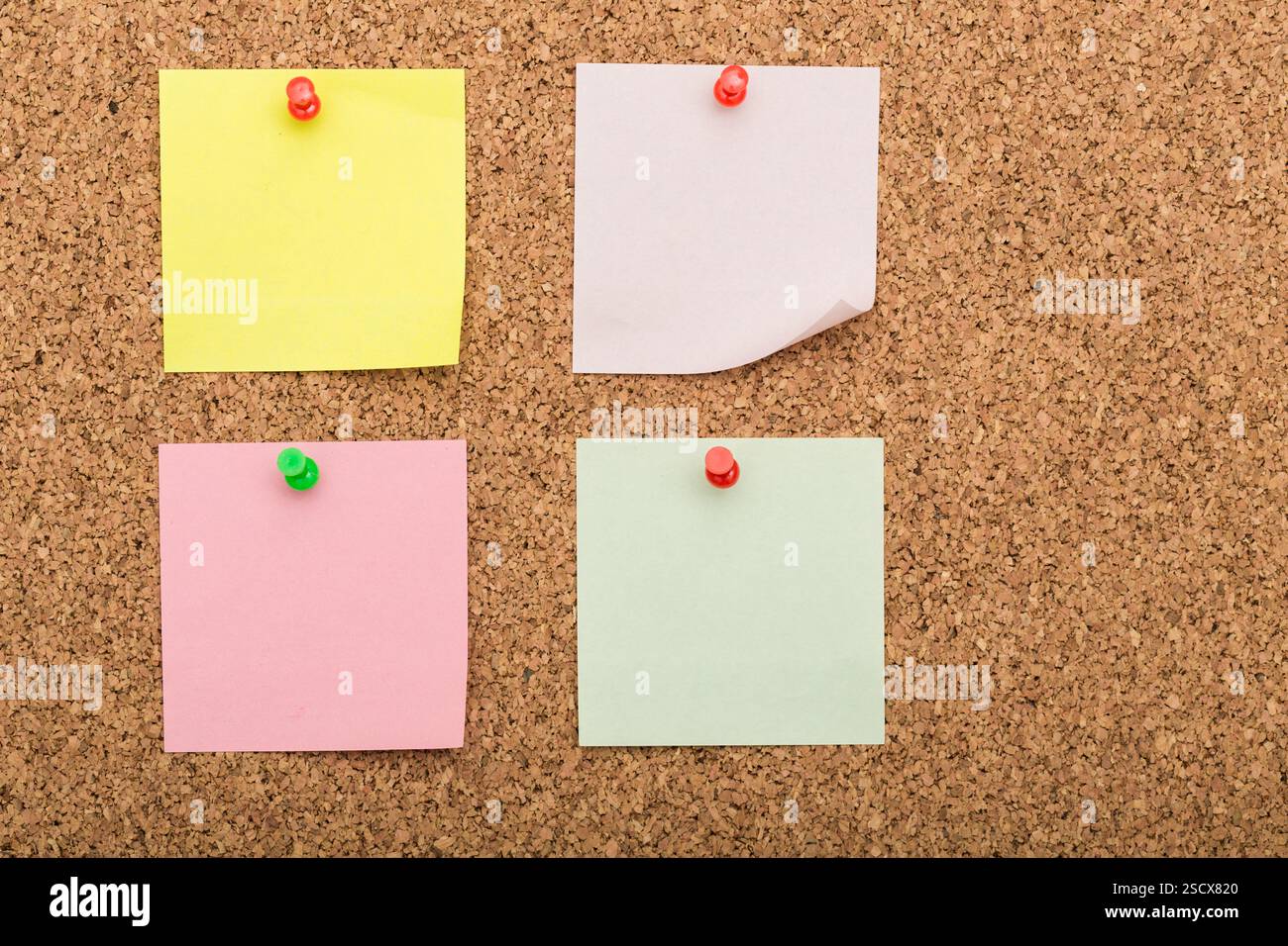 Colorful sticky notes pinned on a corkboard for reminders and ...