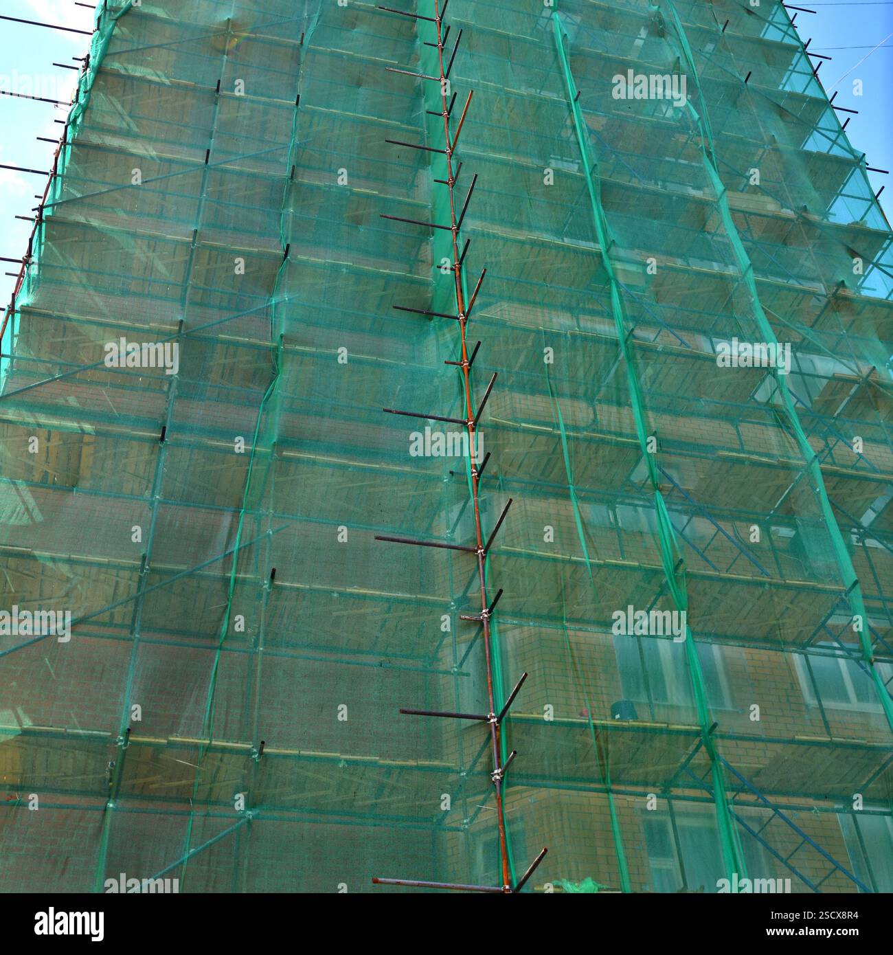 Multi-storey residential building with a scaffolding and safety net ...