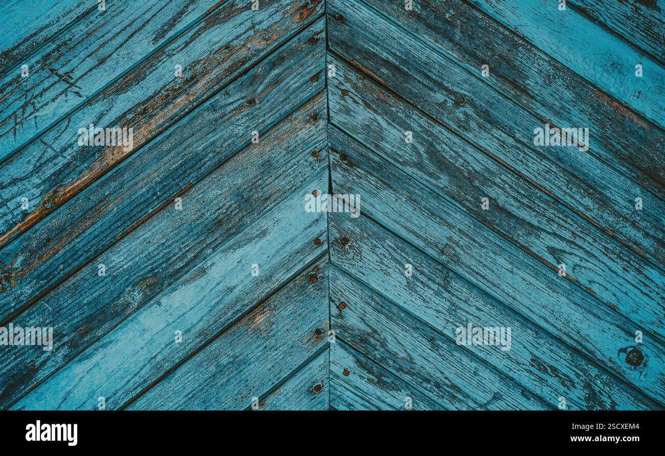 Connection of boards nailed together and covered with old paint. View ...