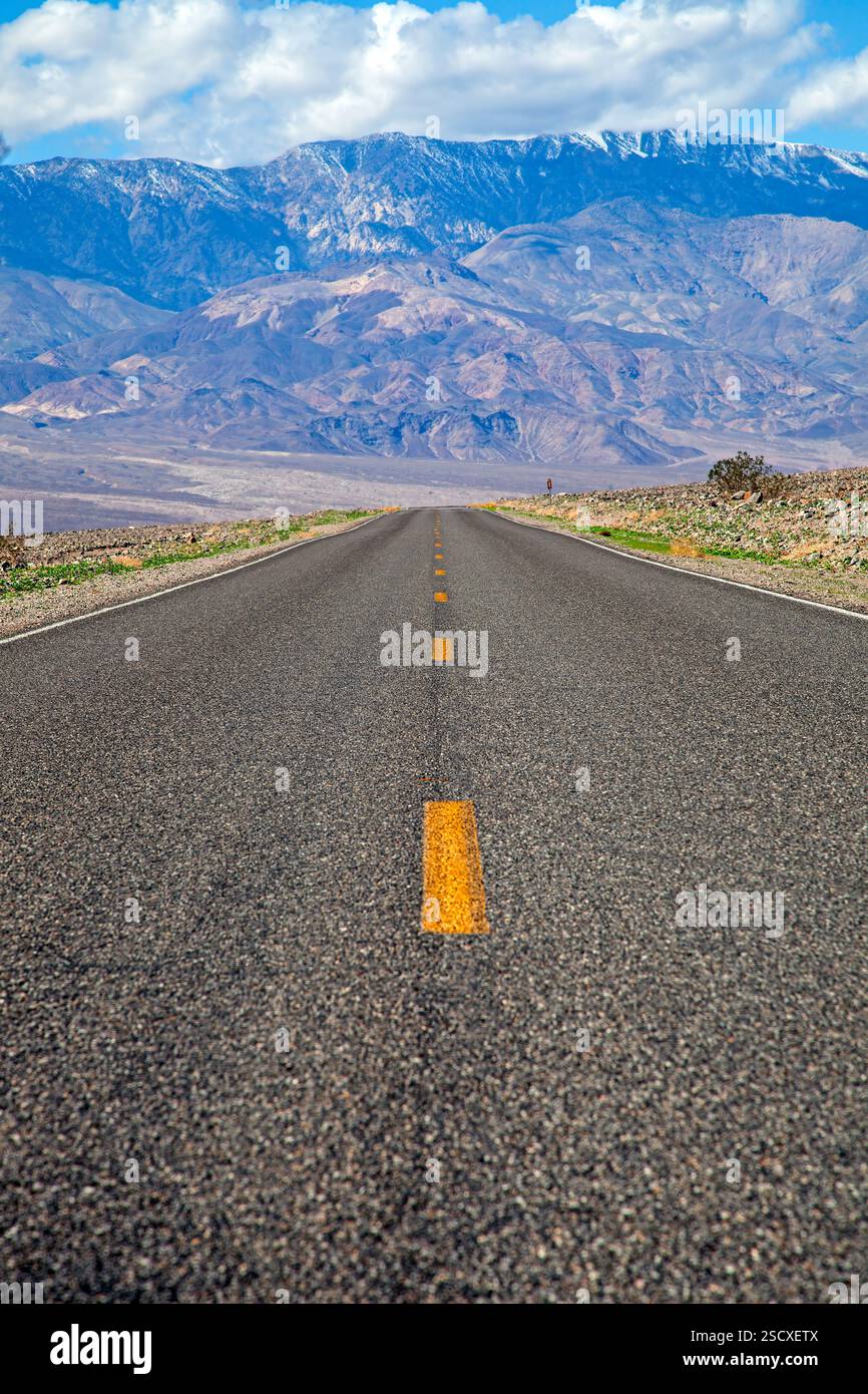 A long desert road disappearing into the distant mountains of Arizona ...