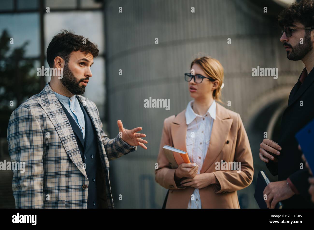 Business people brainstorming project strategies in urban outdoor ...