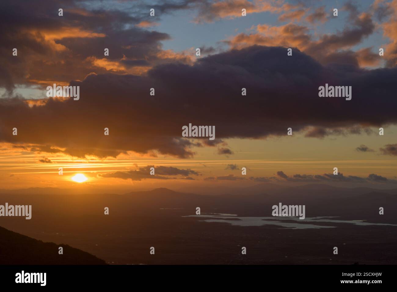 Sun rising at dawn in the mountains with a sky with clouds in the lands ...