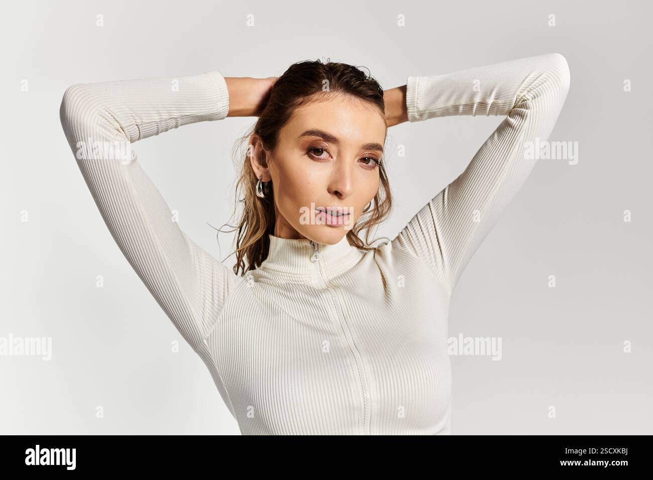 Stunning young woman showcases chic attire fashion in elegant pose ...