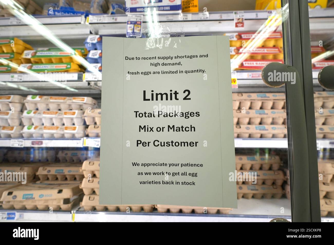 A sign limiting the sale of egg packages for customers is displayed at ...