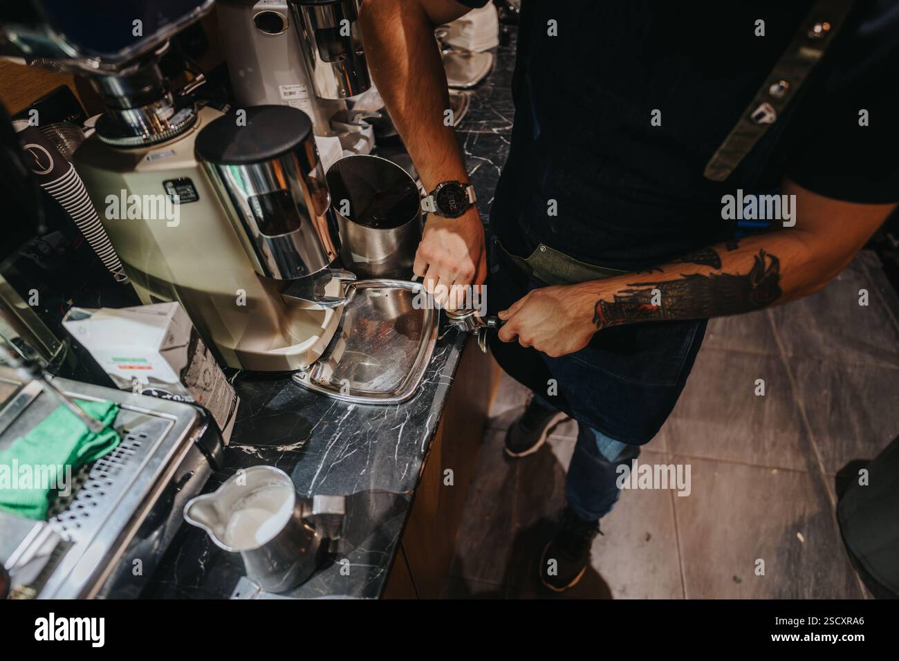 Barista crafting coffee using espresso machine in a modern coffee shop ...