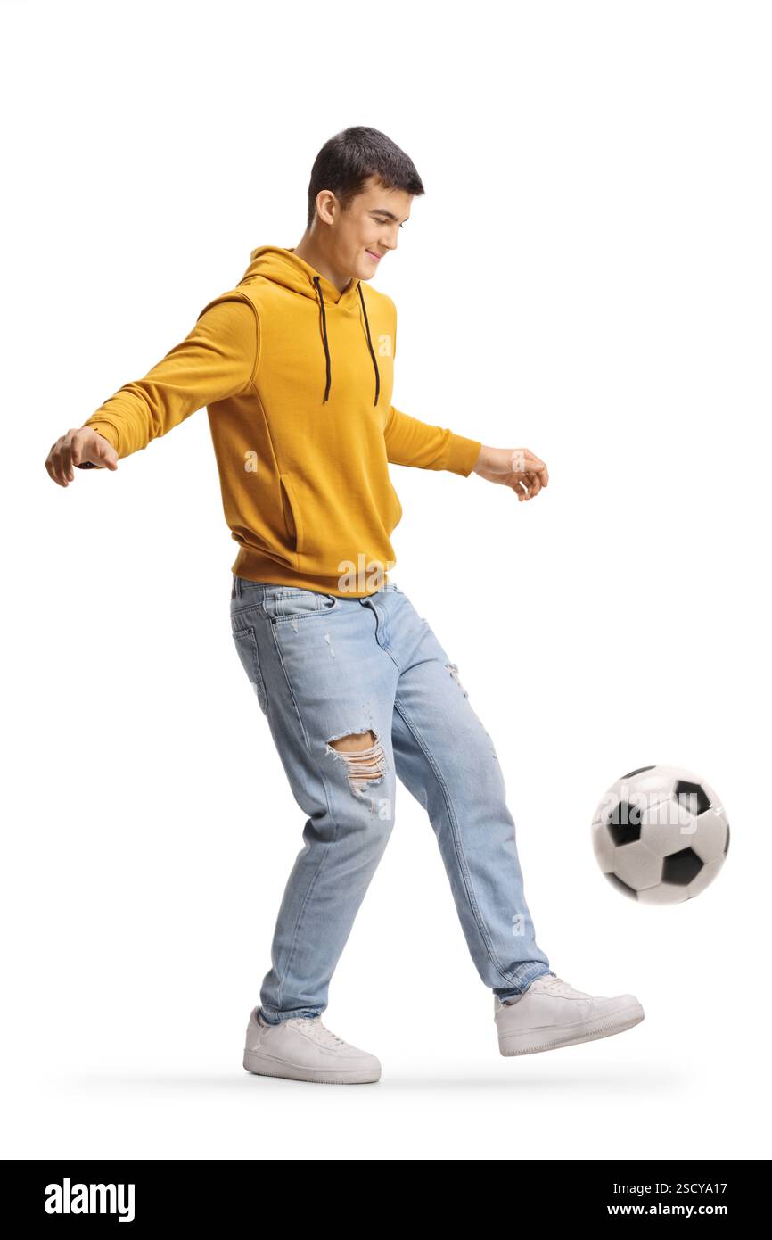 Male teenager juggling with a football isolated on white background ...