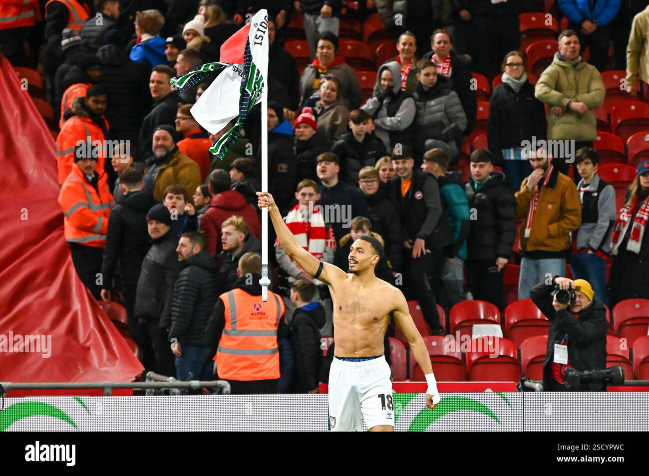 Wilson Isidor lifts a corner flag at full time to celebrate Sunderland ...