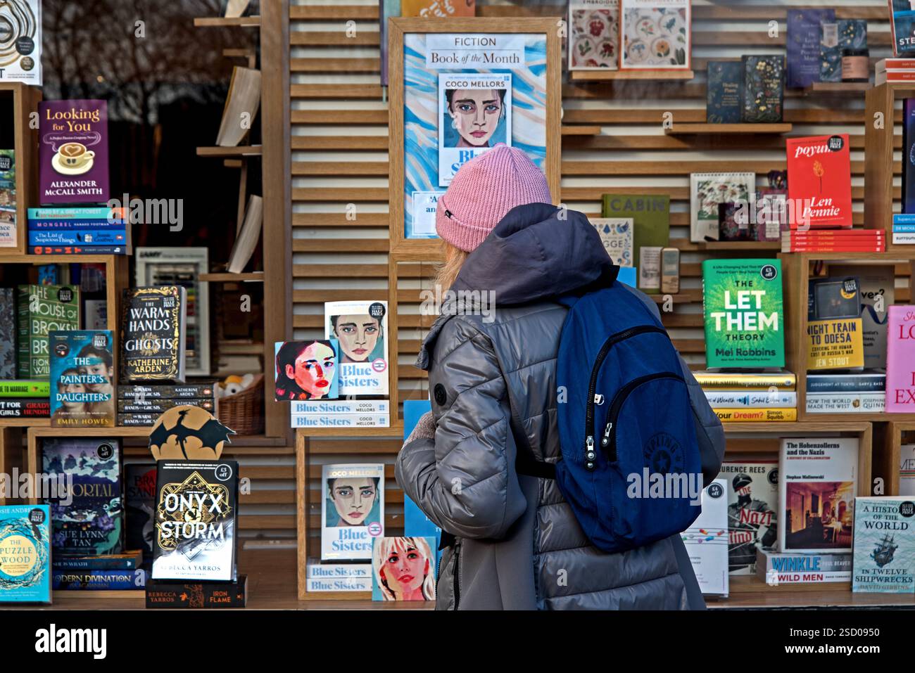 Woman looking at books on display in the window of Waterstones on ...