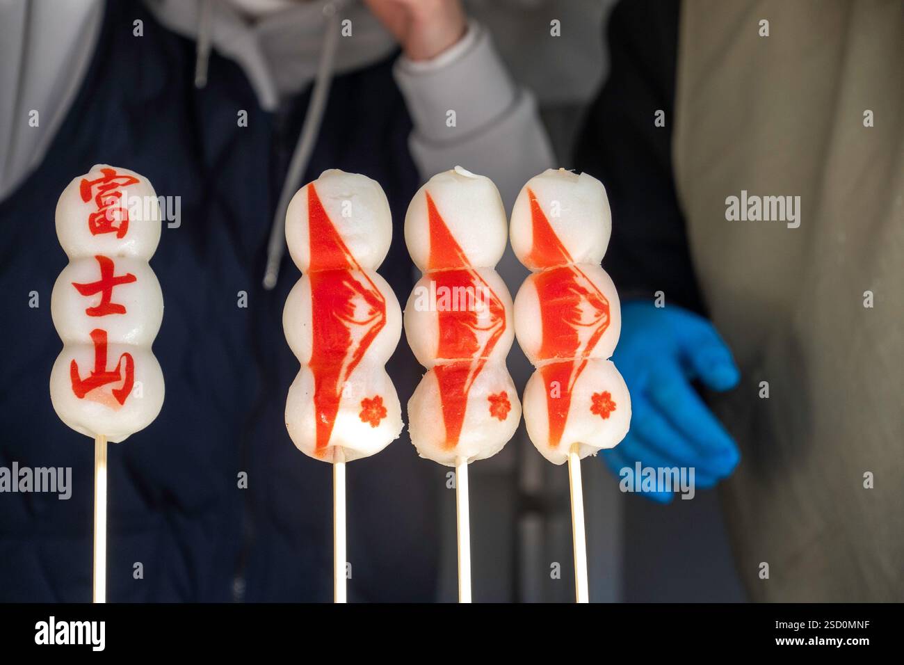 Colorful dango treats displayed at a vibrant food stall in Japan ...