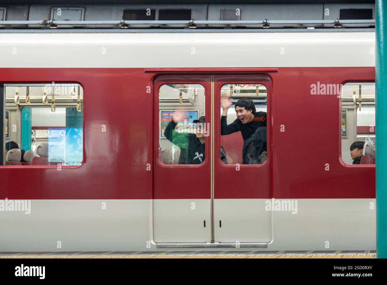Kyoto, Japan - Dec 27 2024: Travelers wave goodbye as the train departs ...
