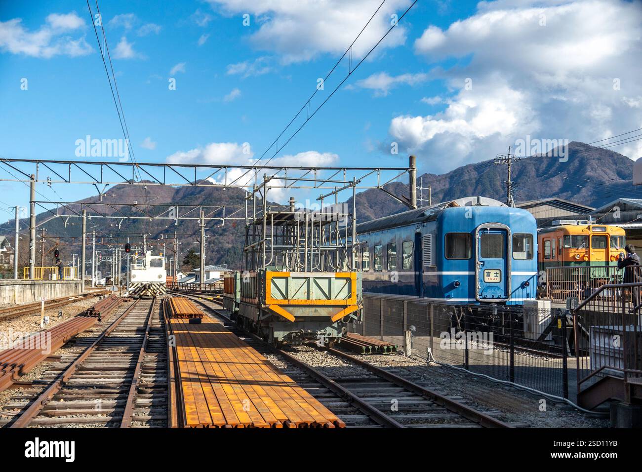 Train yard in Japan with multiple vintage trains and scenic mountains ...