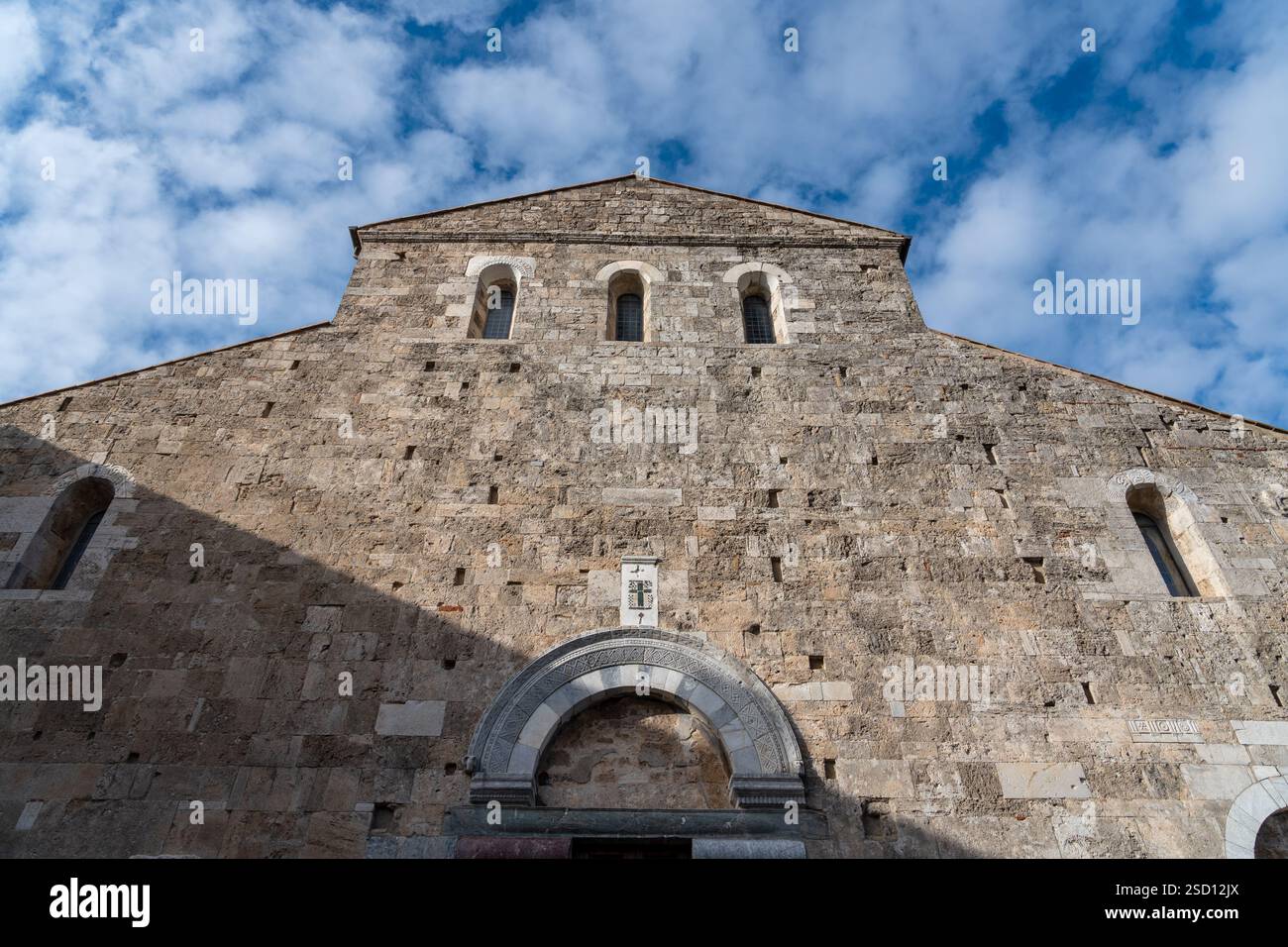 the majestic façade of the ancient medieval stone Romanesque-style ...
