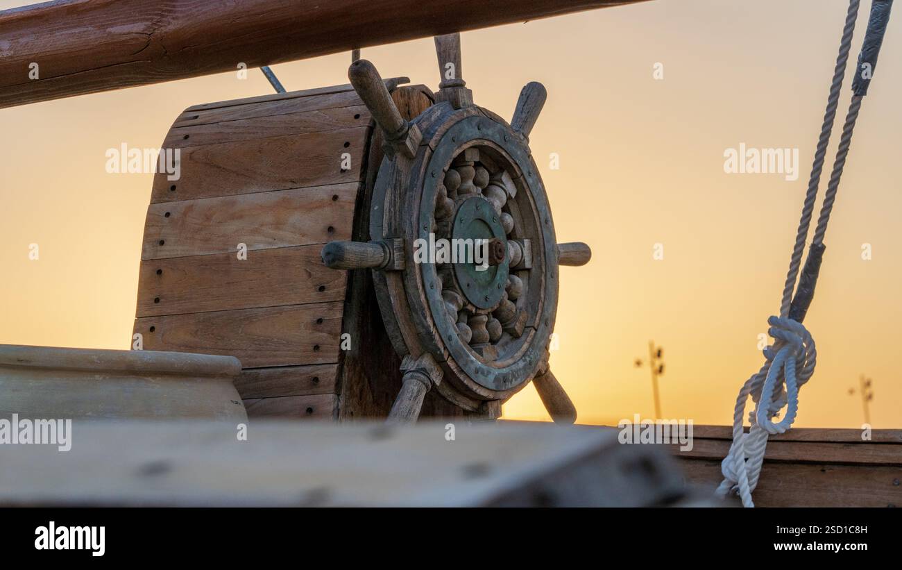 Doha, Qatar February 7, 2025: An antique wooden steering wheel from a ...