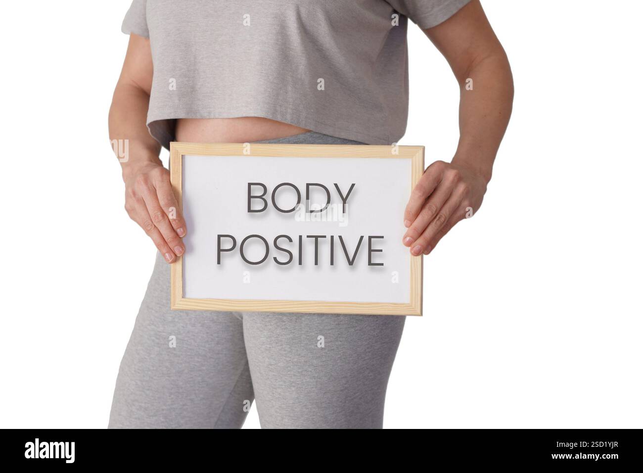 body positive concept. curvy woman dressed in gray sportswear and a ...