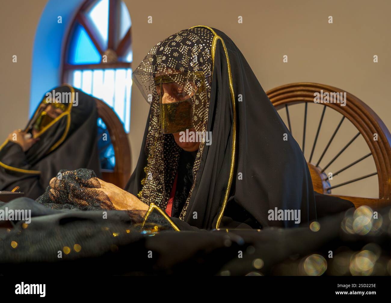 Doha, Qatar, January 28, 2025: A Qatari woman in local attire carefully ...