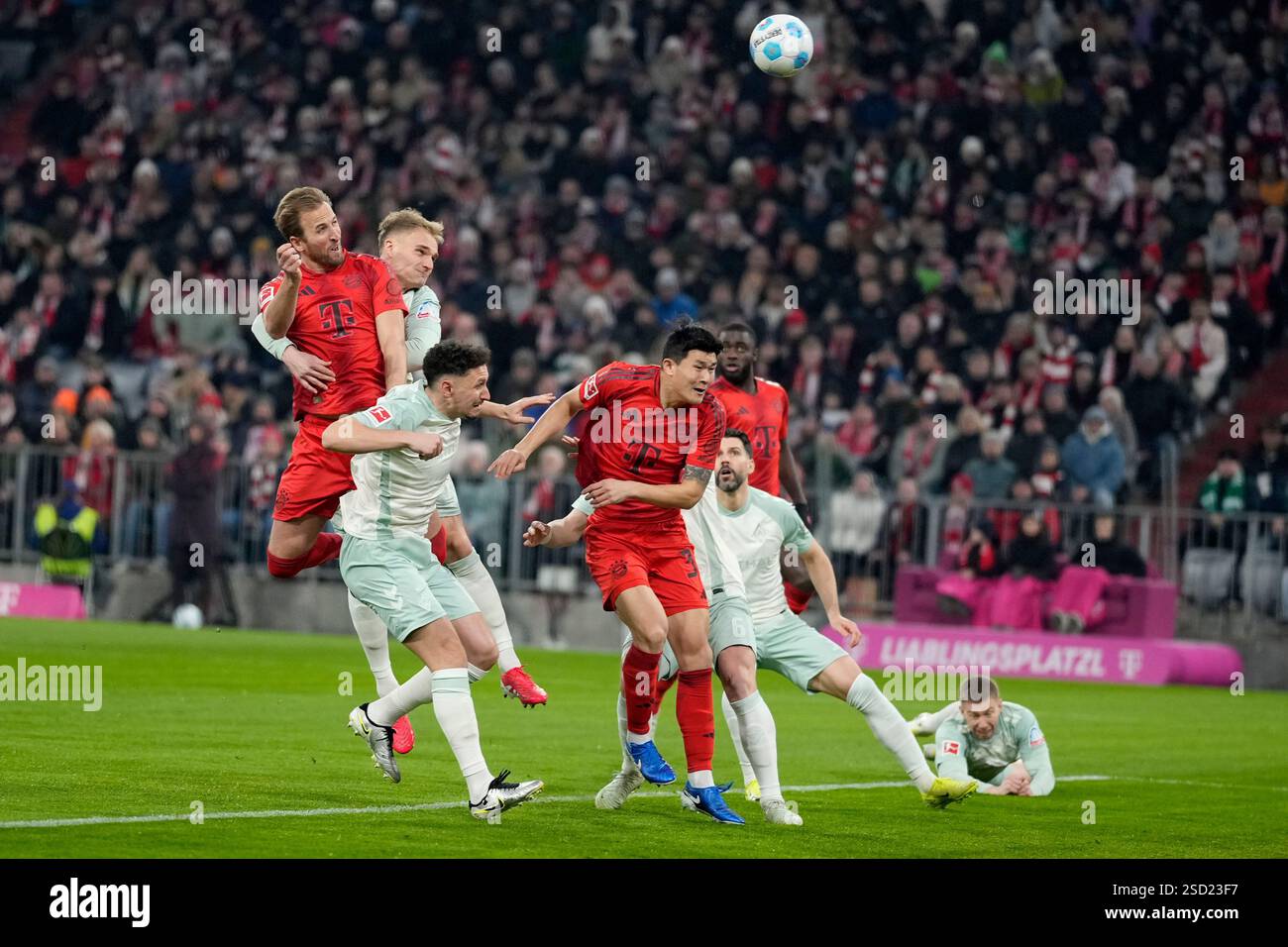Bayern's Harry Kane, left, and Bayern's Kim Min-jae, center, go up for ...