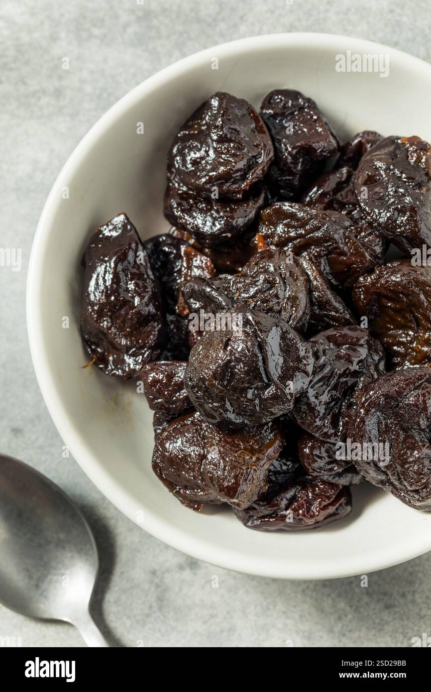 Organic Raw Dried Plum Prunes in a Bowl Stock Photo - Alamy