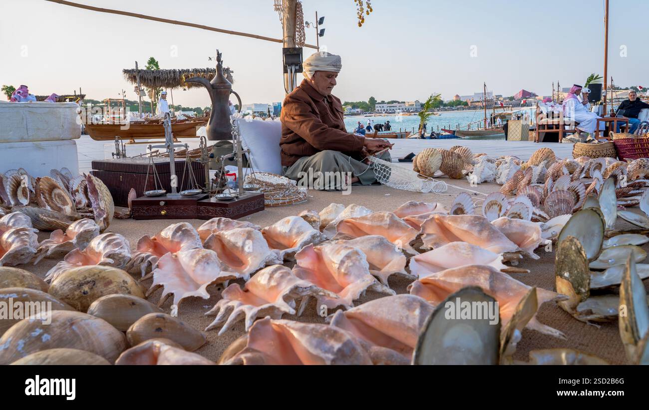 Doha,qatar -February 7, 2025: A merchant displaying sea shells and ...