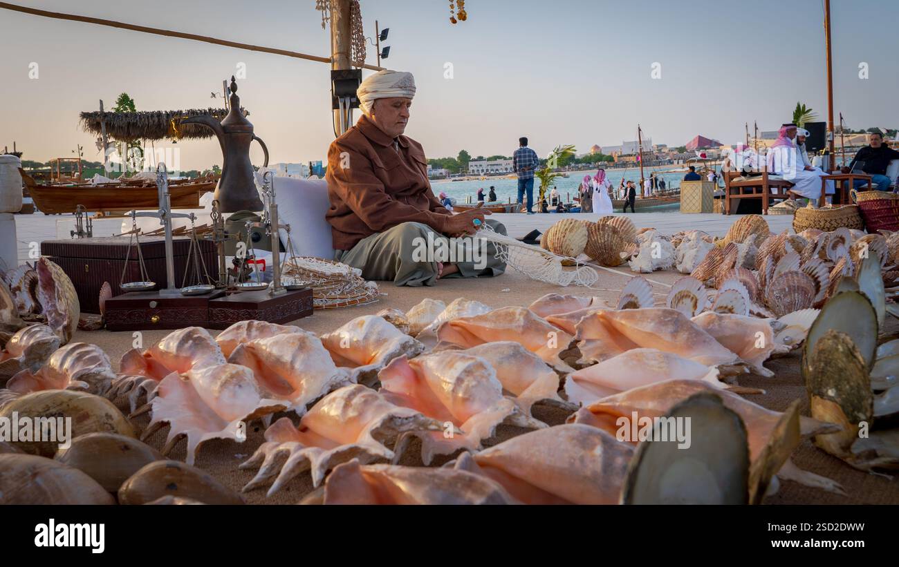 Doha,qatar -February 7, 2025: A merchant displaying sea shells and ...
