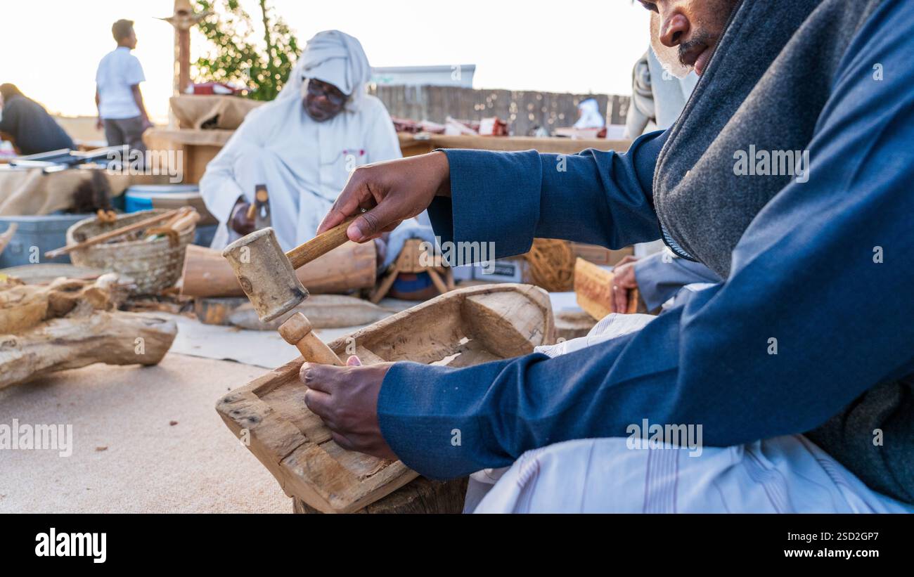 Doha, Qatar February 7, 2025: Arab men creating a traditional wooden ...