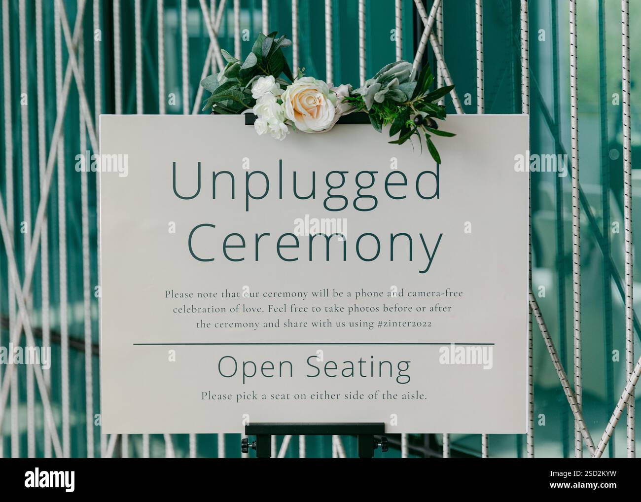 A sign invites guests to an unplugged ceremony, emphasizing a phone ...
