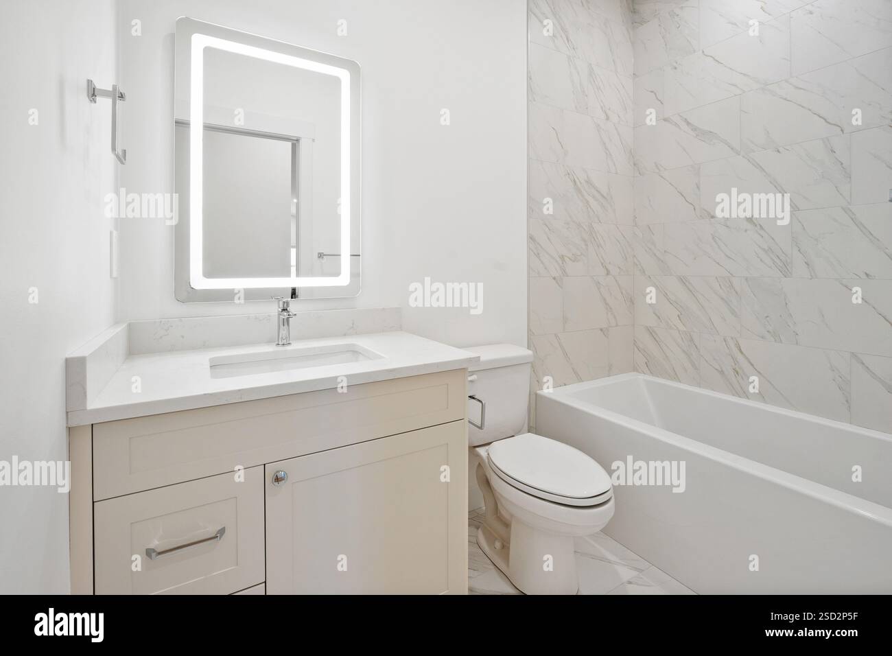 Bathroom with a white toilet, sink, and bathtub. The bathroom is clean ...